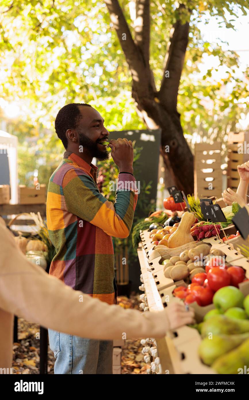 Diverse couple offering fruit from hi-res stock photography and images ...