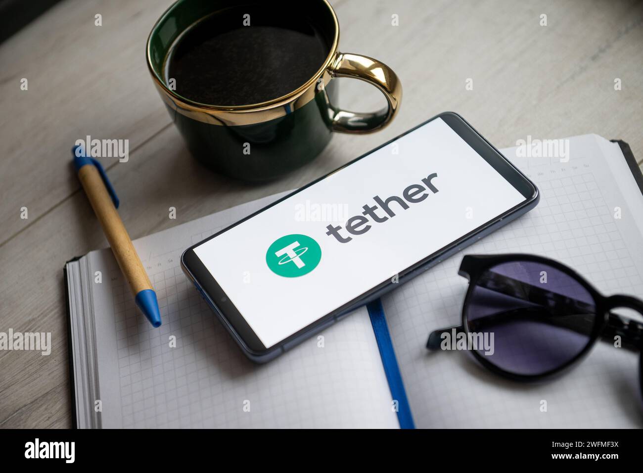In this photo illustration a Tether logo seen displayed on a smartphone ...