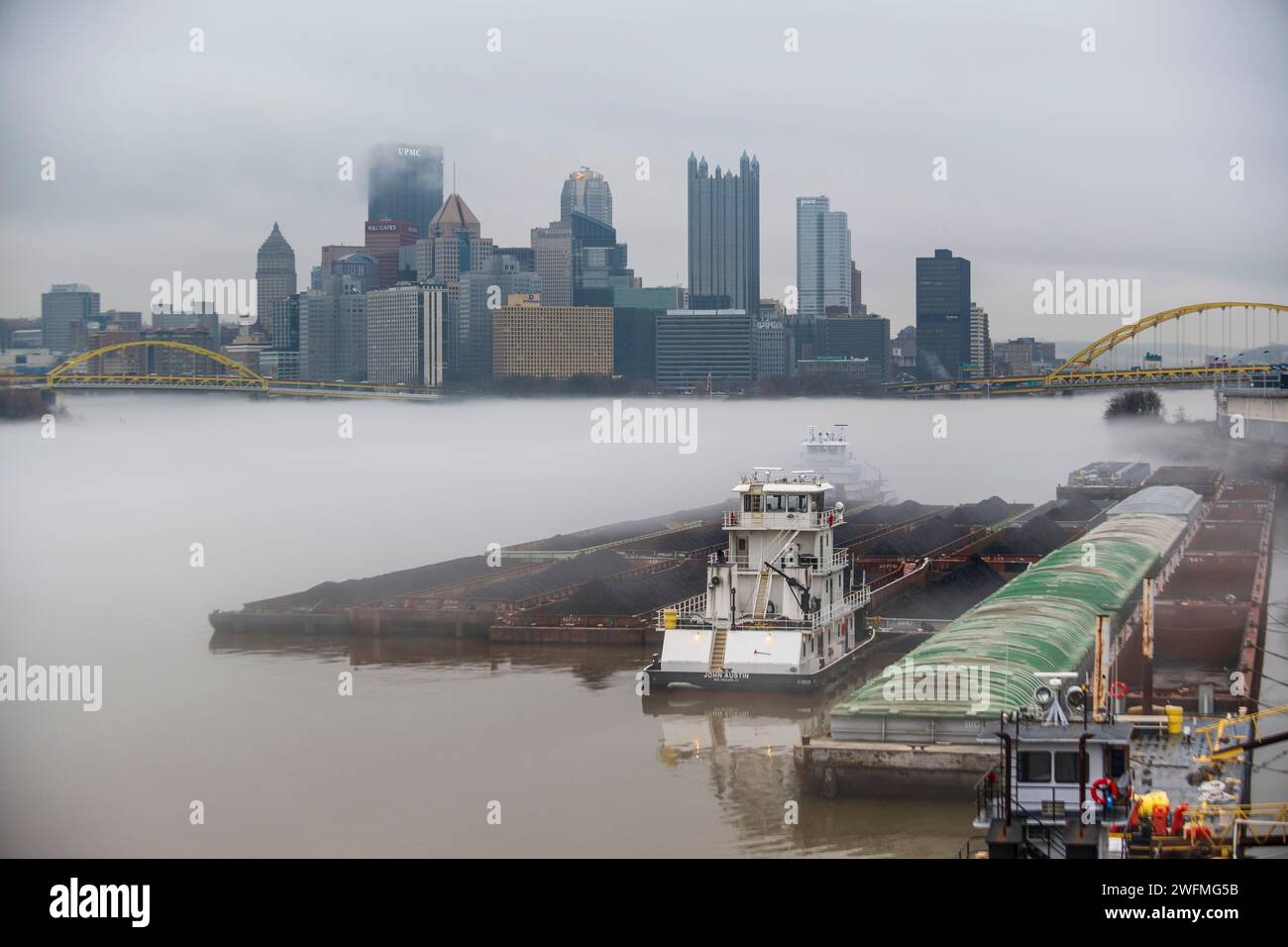 Towboats stage barges during foggy conditions on the Ohio River in ...