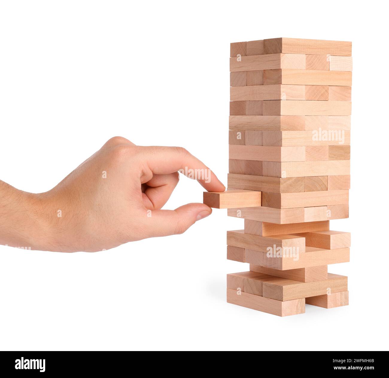 Playing Jenga. Man removing wooden block from tower on white background ...