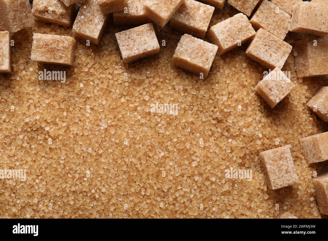 Different types of brown sugar as background, top view. Space for text ...