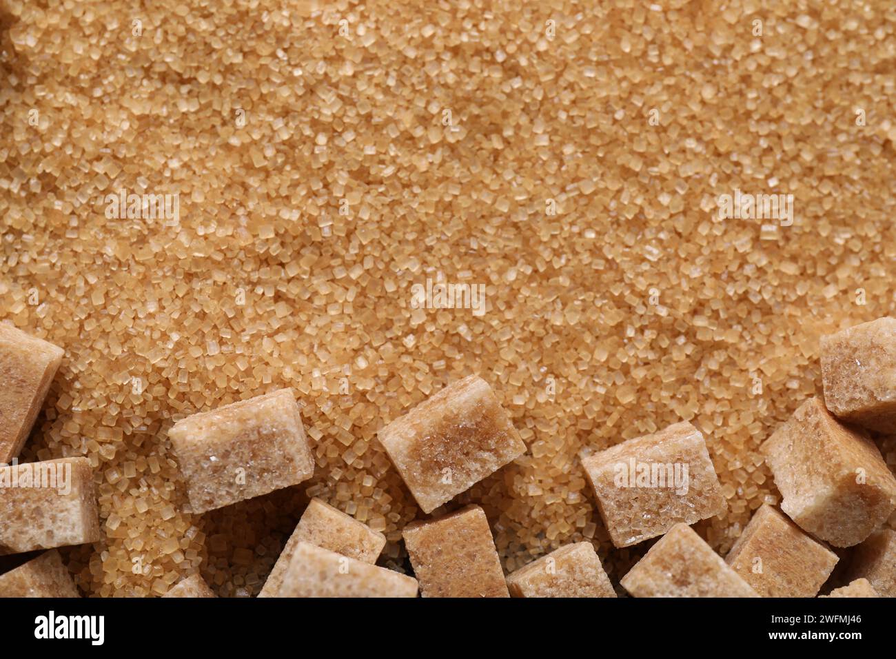 Different types of brown sugar as background, top view. Space for text ...