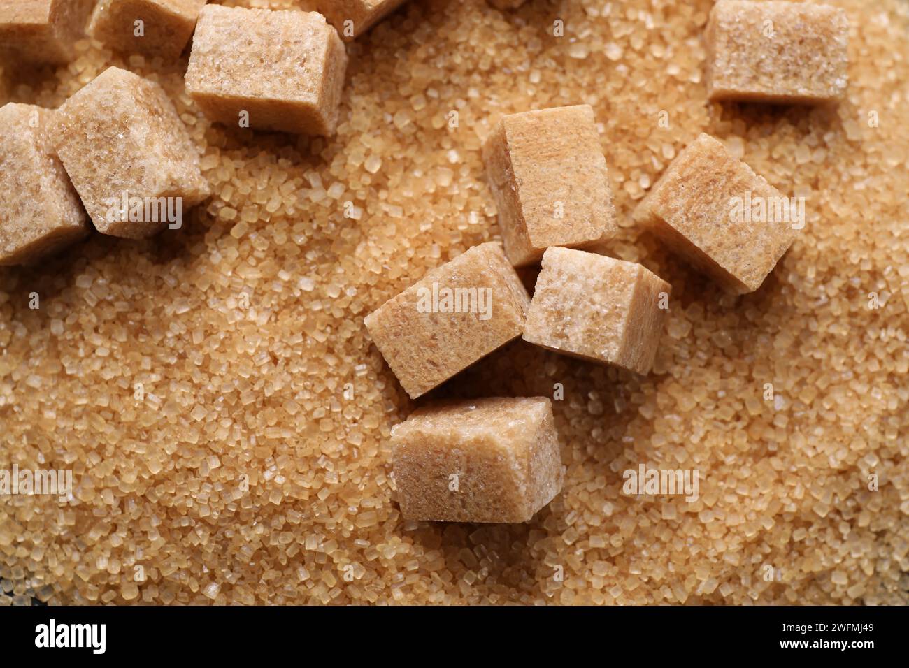 Different types of brown sugar as background, top view Stock Photo - Alamy