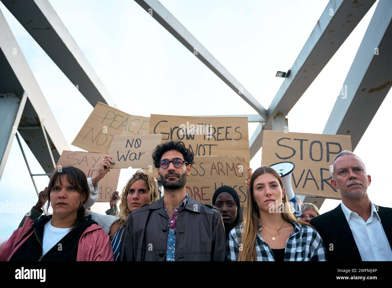 Serious multiracial group demonstrating against the war and violence in ...