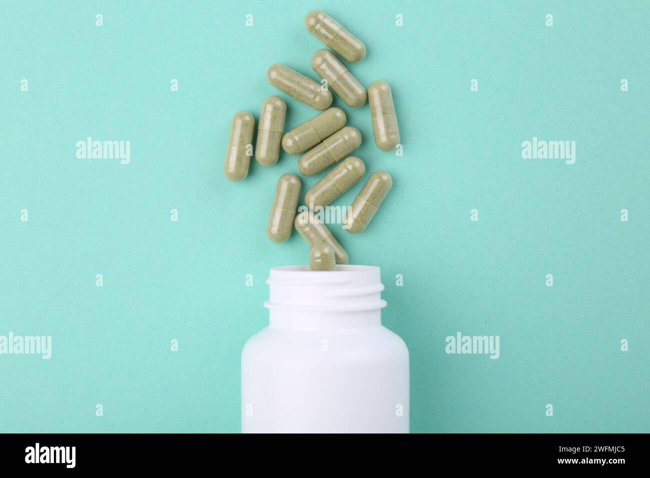 Bottle and vitamin capsules on turquoise background, top view Stock ...