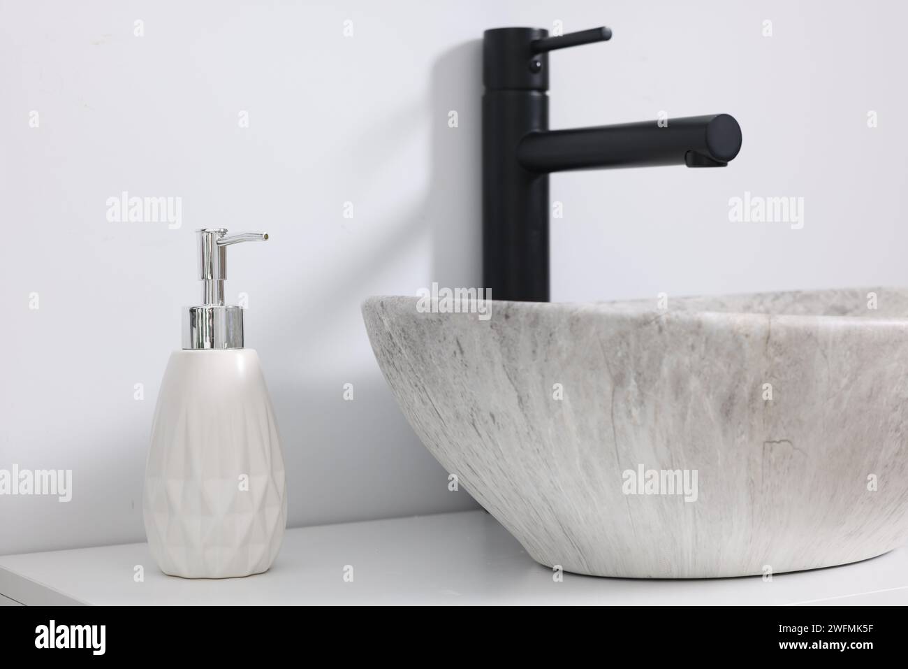 Liquid soap dispenser near sink on bathroom vanity Stock Photo - Alamy