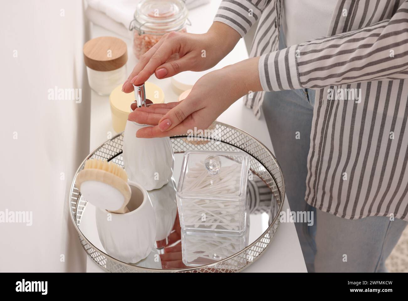 Bath accessories. Woman applying soap on her hand indoors, closeup ...