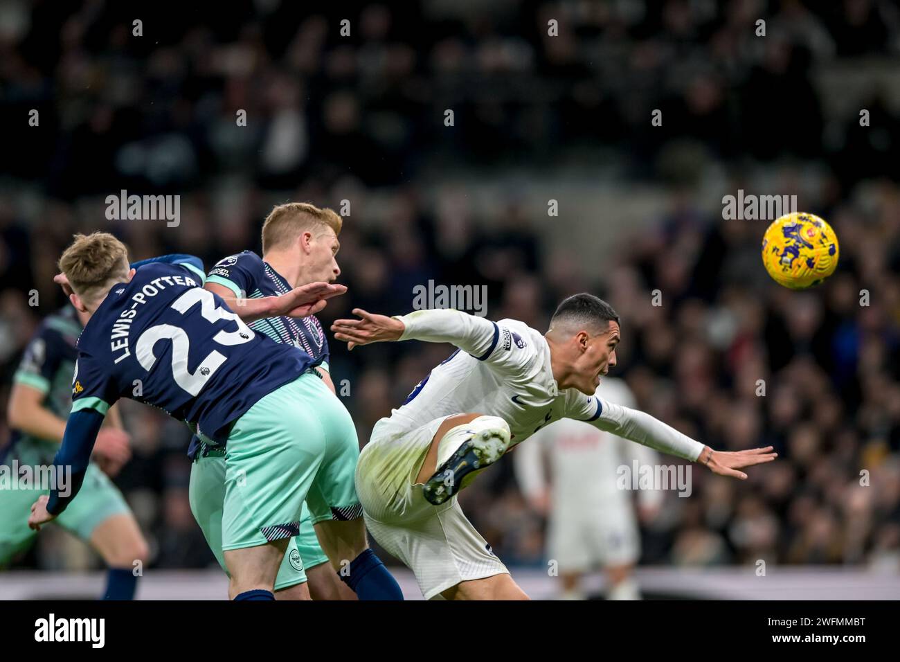 Guglielmo Vicario of Tottenham Hotspur heads he ball as Ben Mee ...
