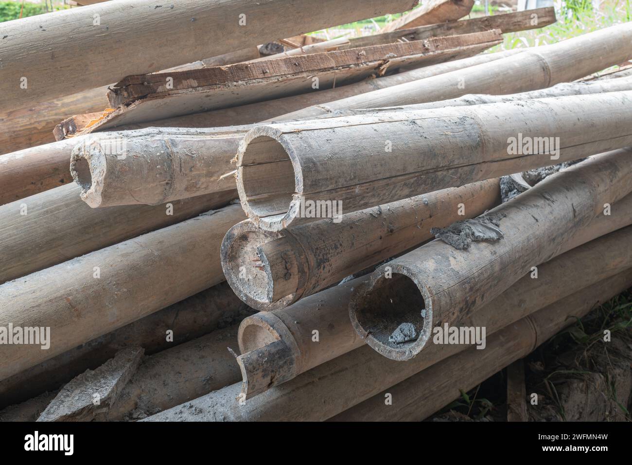 A pile of bamboo trunks at a construction site Stock Photo - Alamy