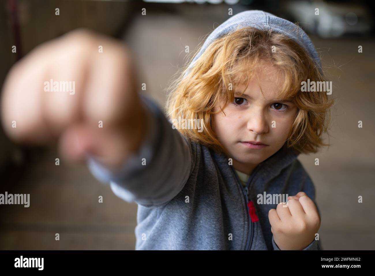 Aggressive bad child. Kid boy in hoodie fighting. Little kid boy fight ...