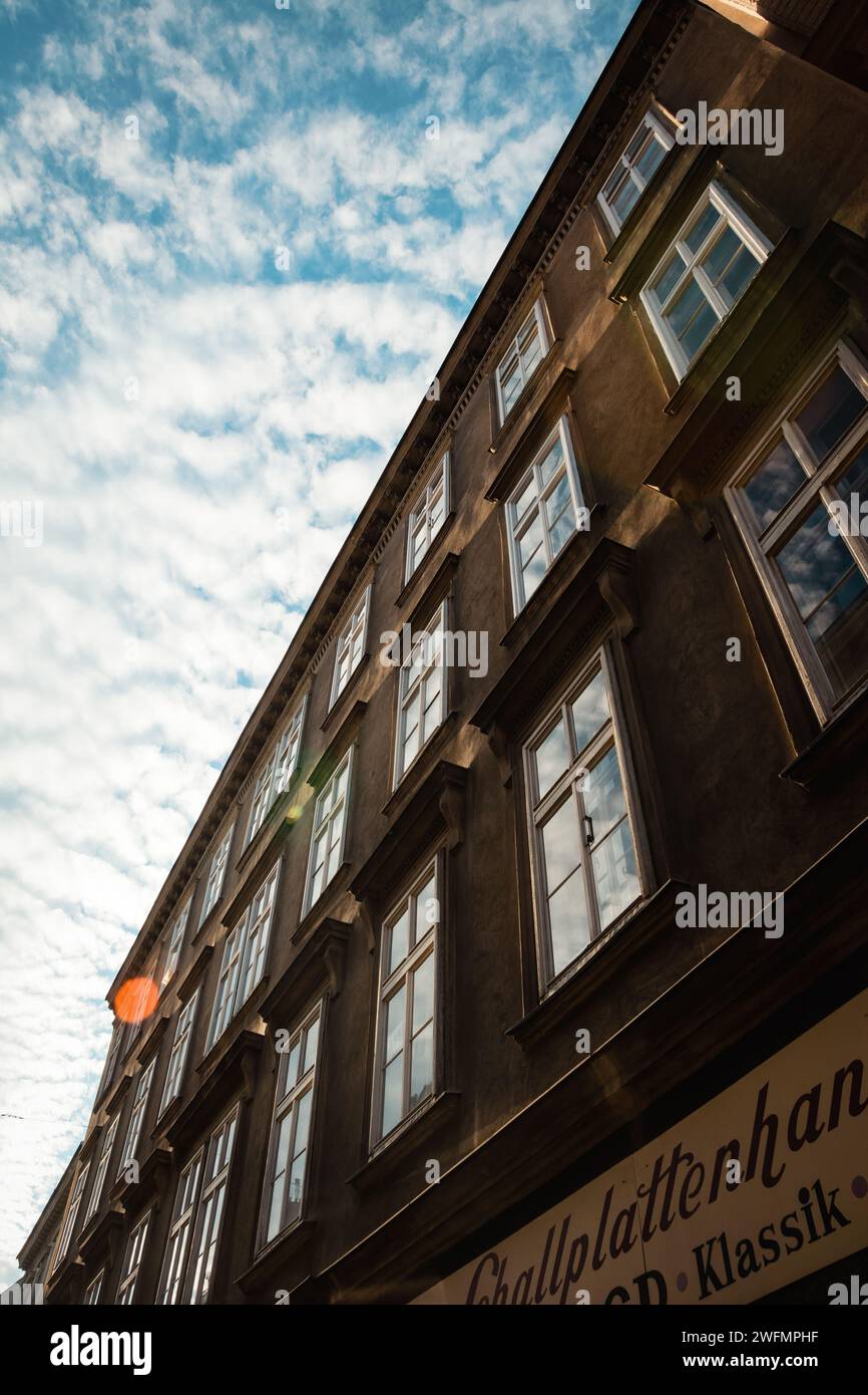 old brown building in the rays of afternoon sun. Facade of 18th century ...