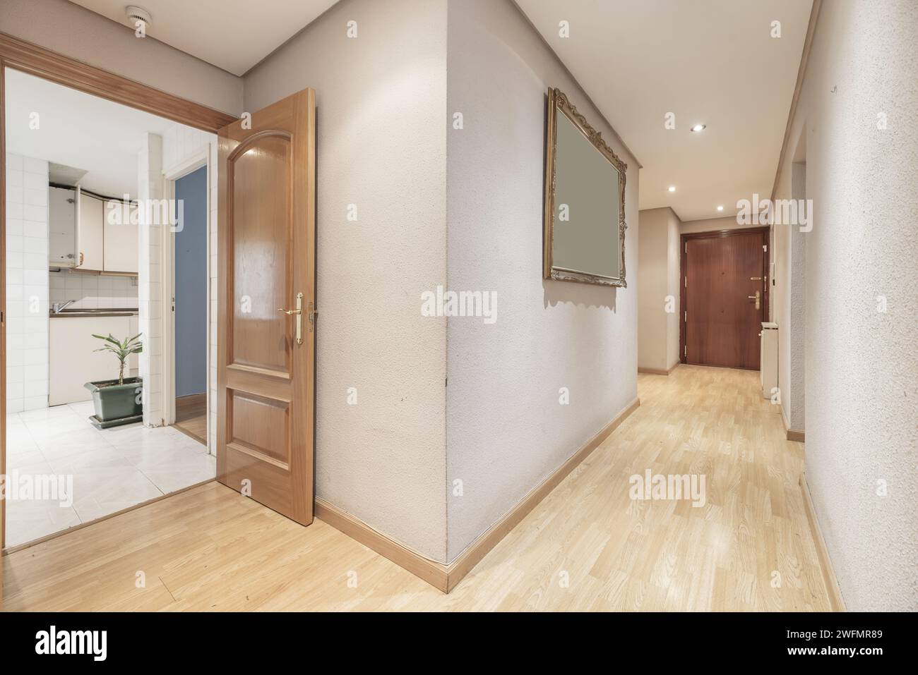 Hallway of a residential house with oak wooden doors, access to kitchen ...