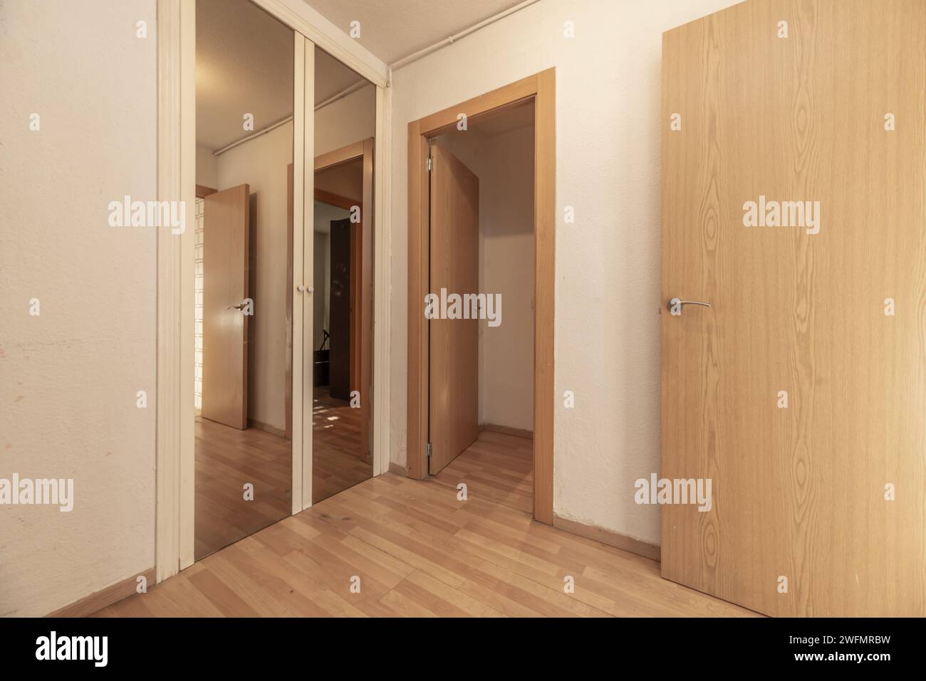 Small hall of a home with light floors, built-in wardrobe with mirrors ...