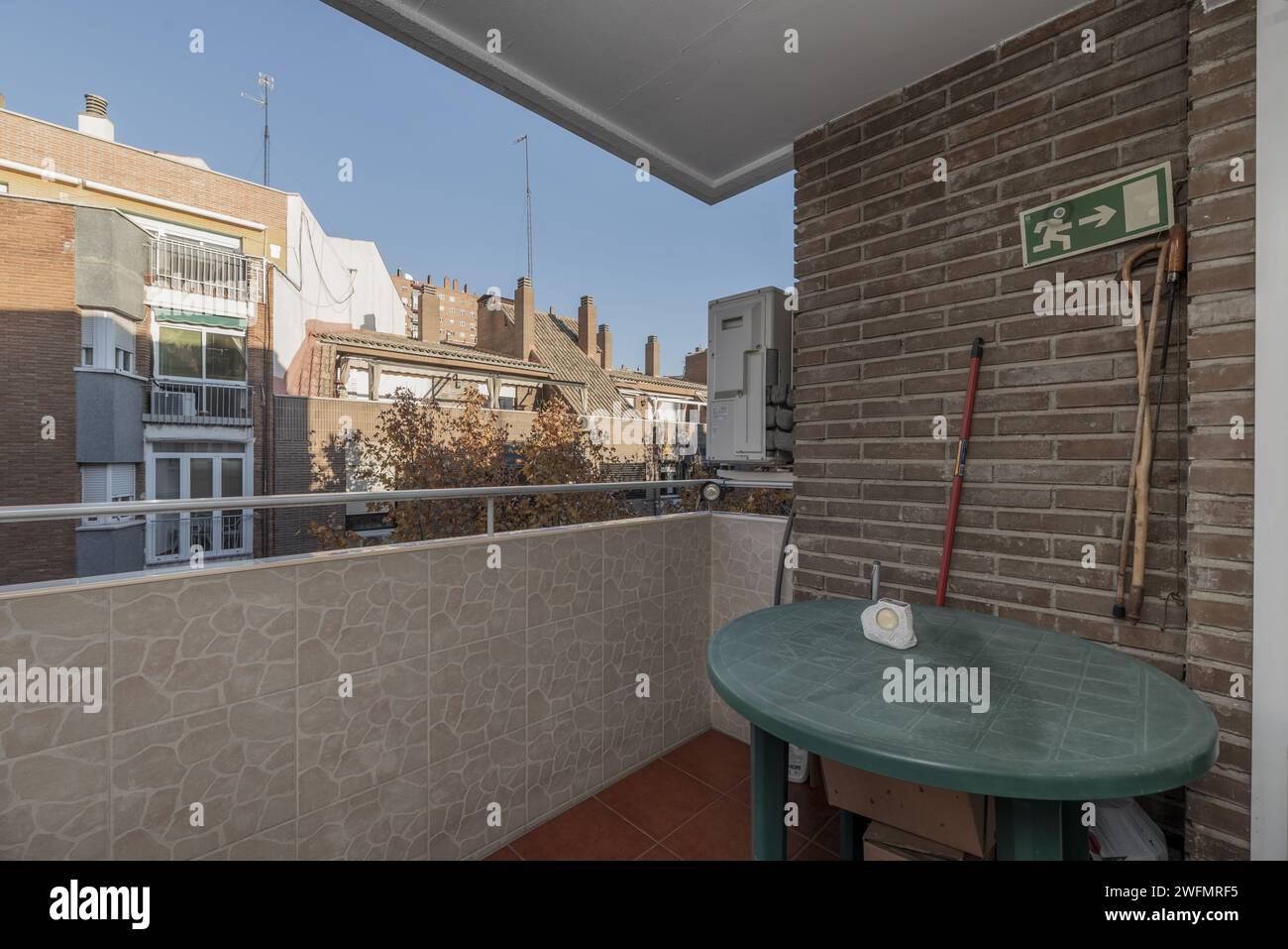 Small terrace of a residential home on a narrow urban street with ...