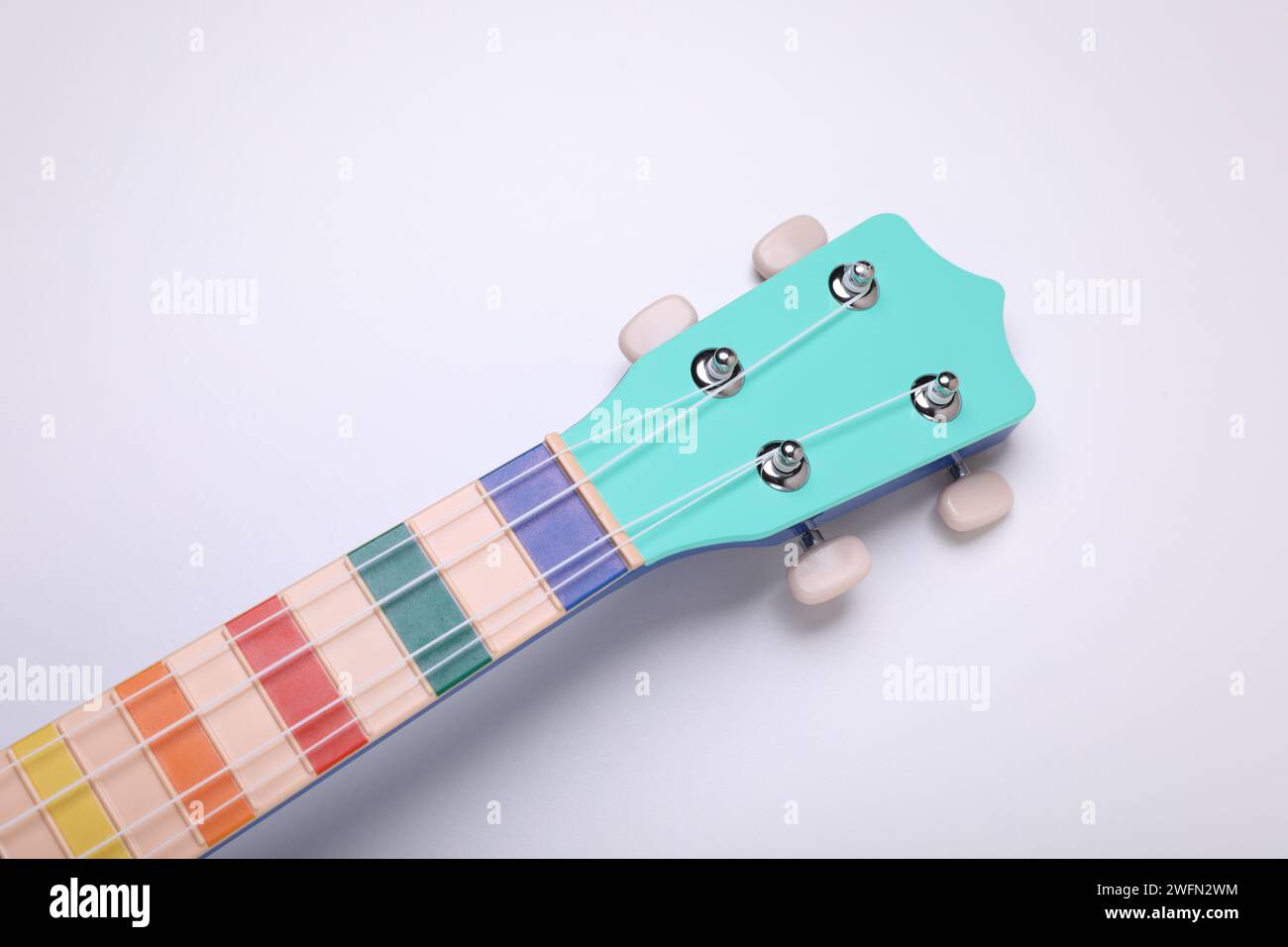 Colorful ukulele neck on white background. String musical instrument ...