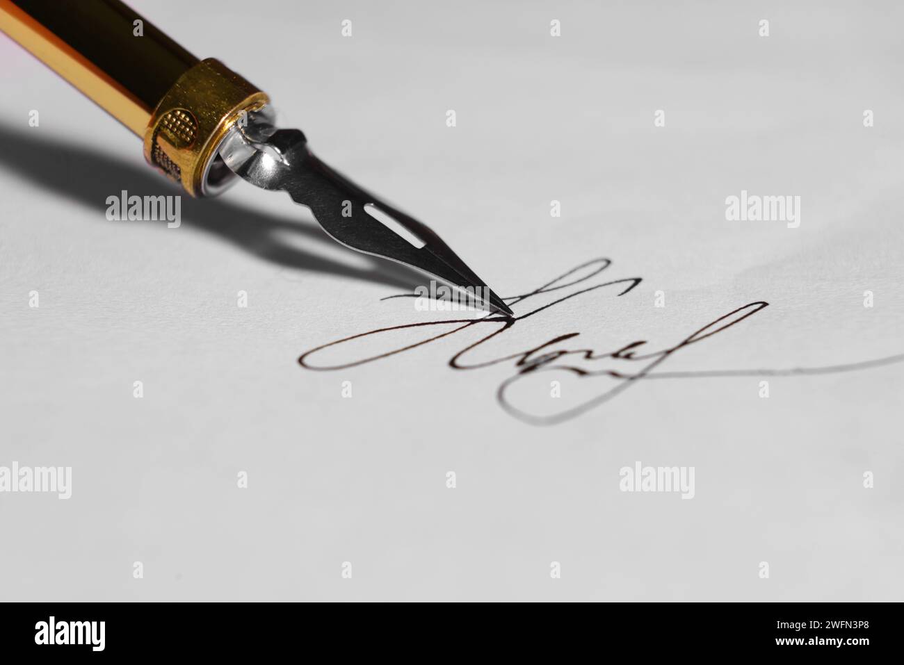 Signing on sheet of paper with fountain pen, closeup Stock Photo - Alamy