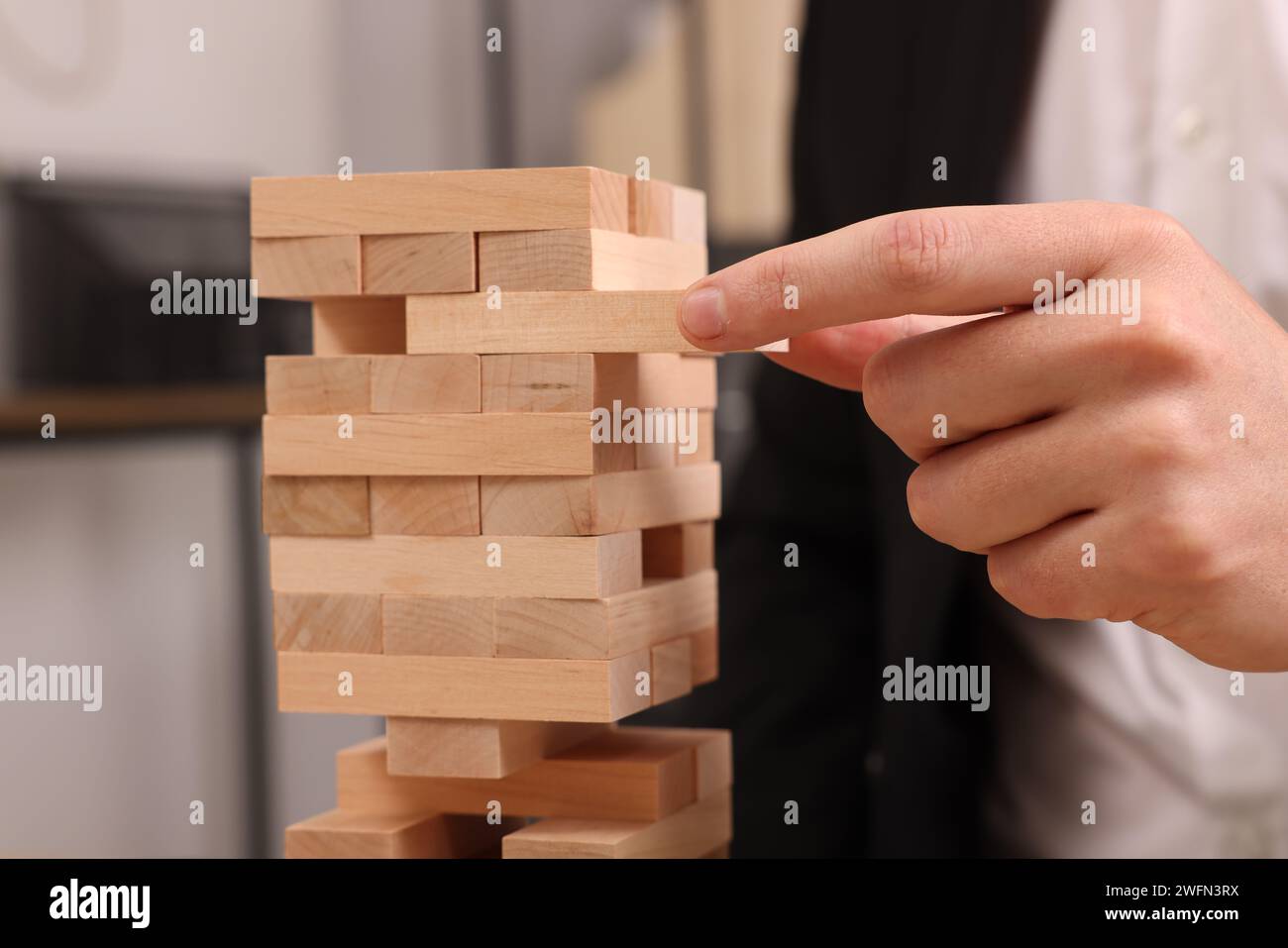 Man playing jenga wooden block hi-res stock photography and images - Alamy