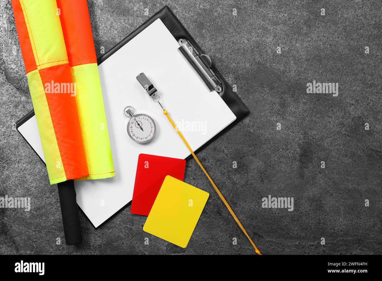 Different referee equipment on grey table, top view. Space for text ...