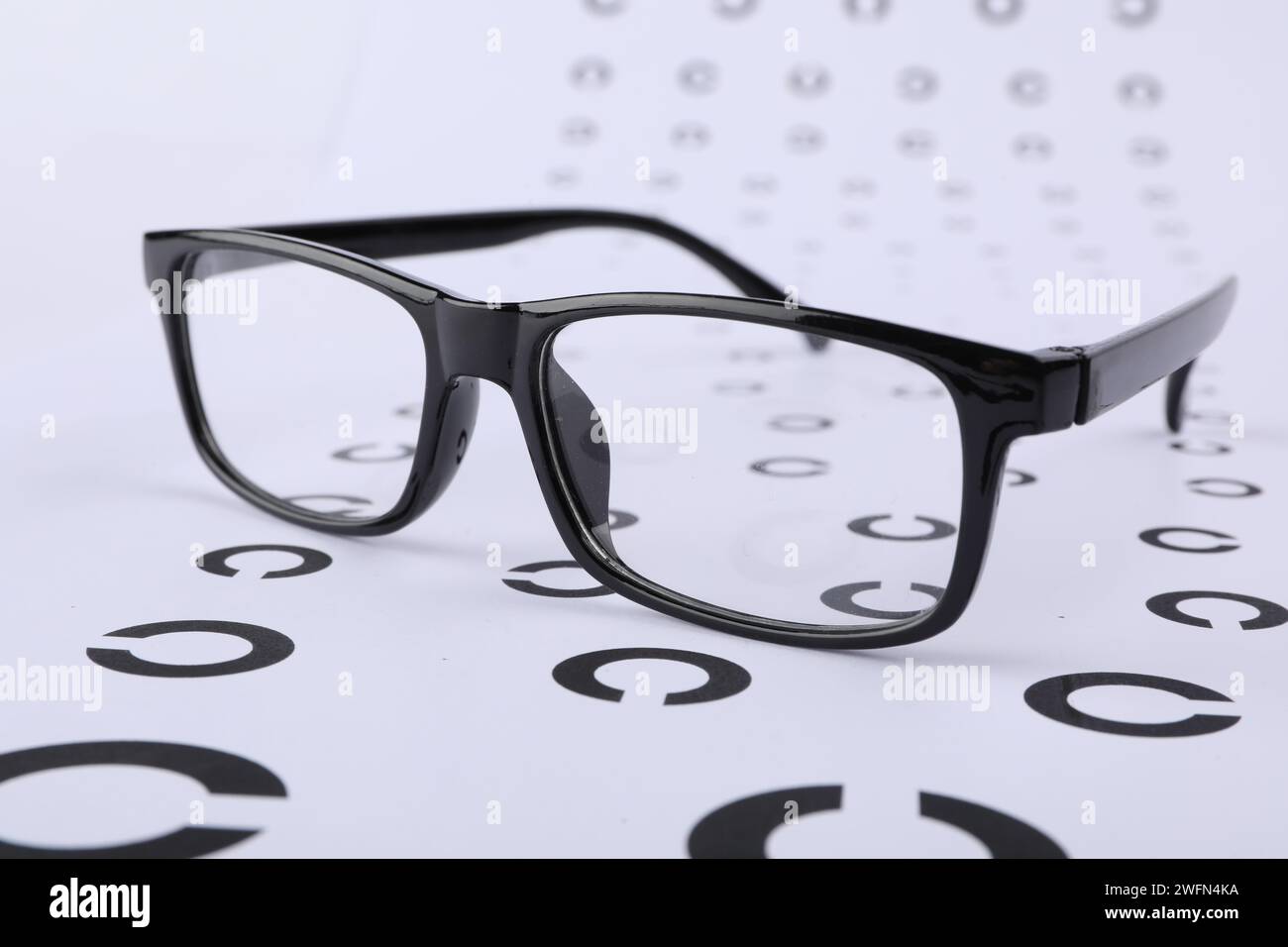 Vision test chart and glasses on white background, closeup Stock Photo ...