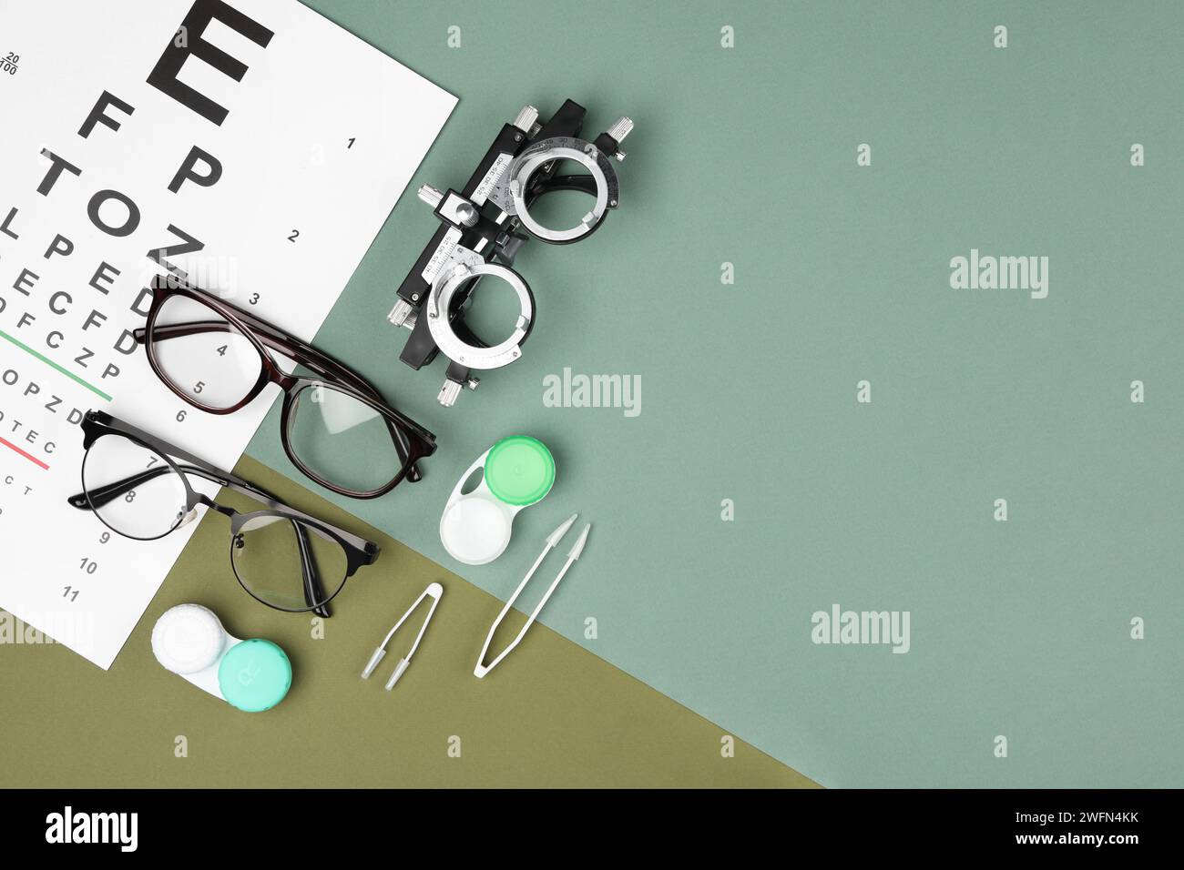 Flat lay composition with vision test chart and glasses on color ...