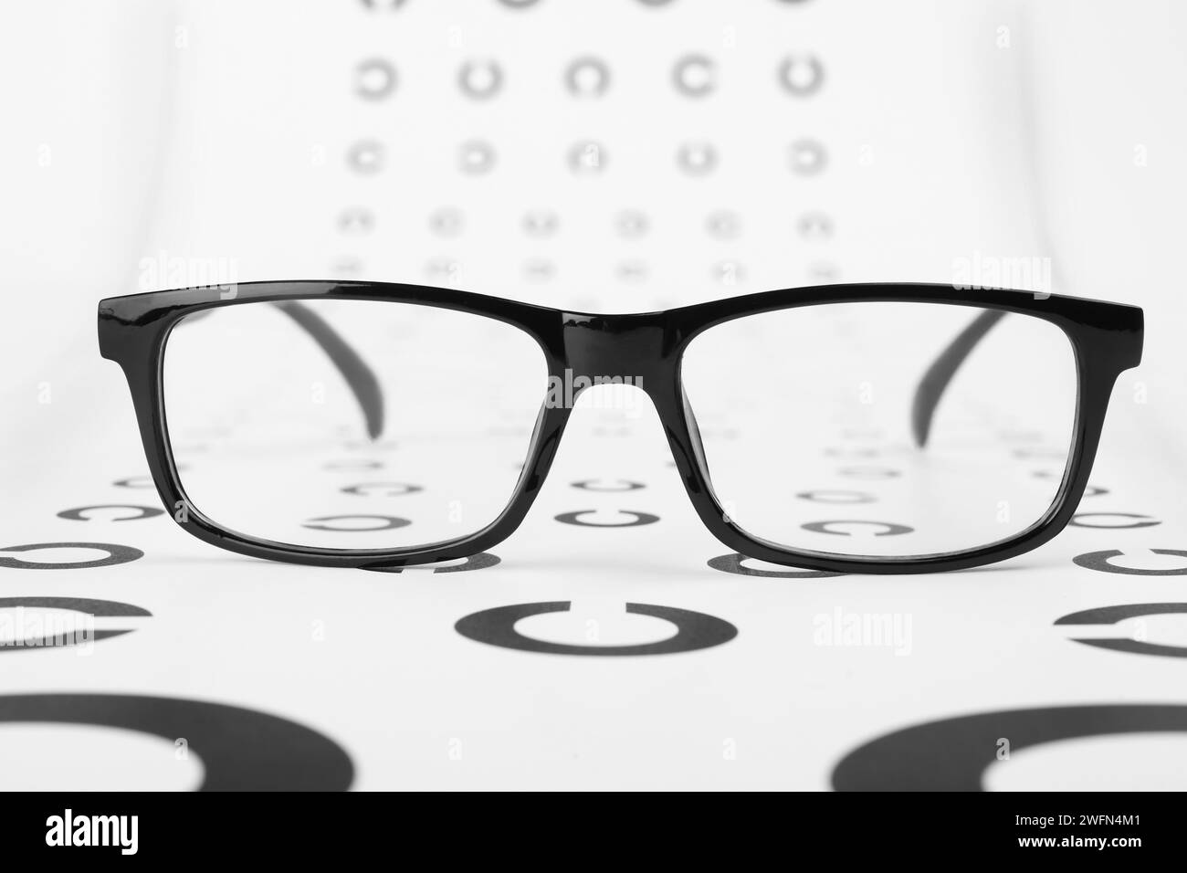 Vision test chart and glasses on white background, closeup Stock Photo ...