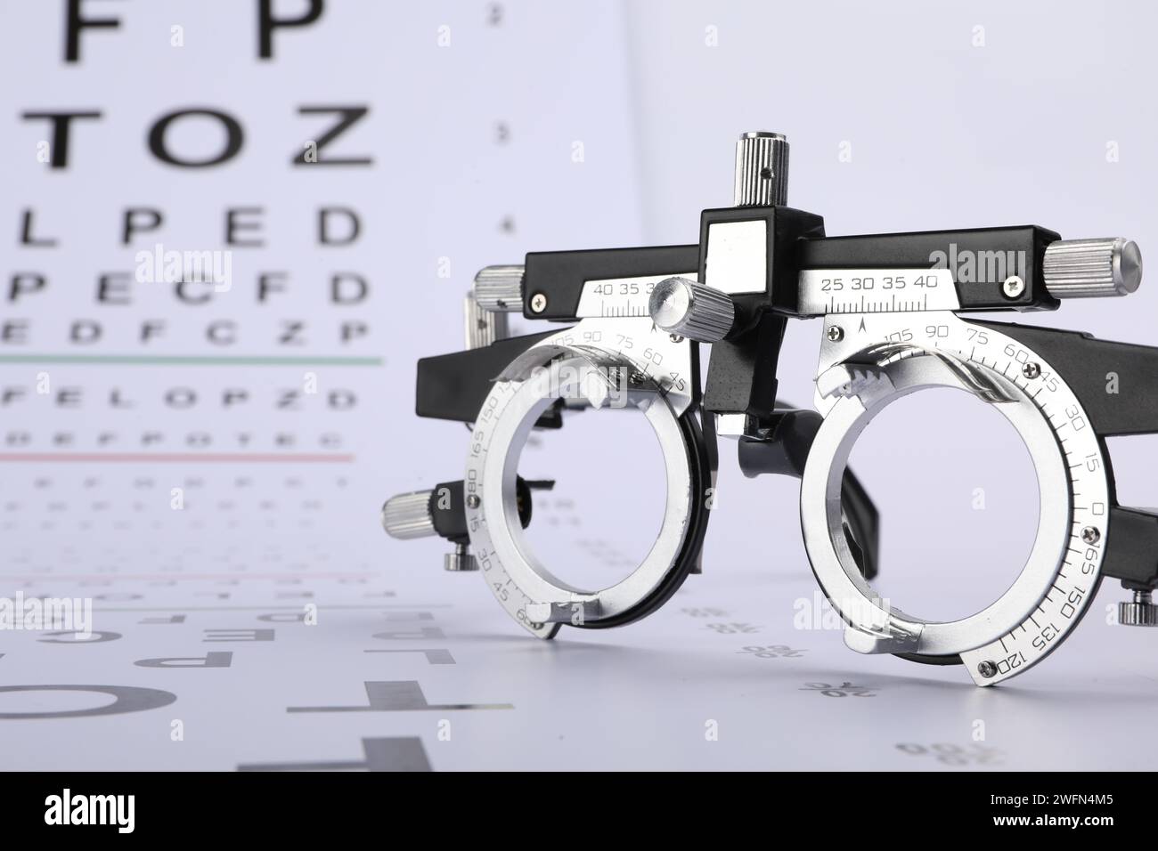 Vision test chart and trial frame on white background, closeup Stock ...