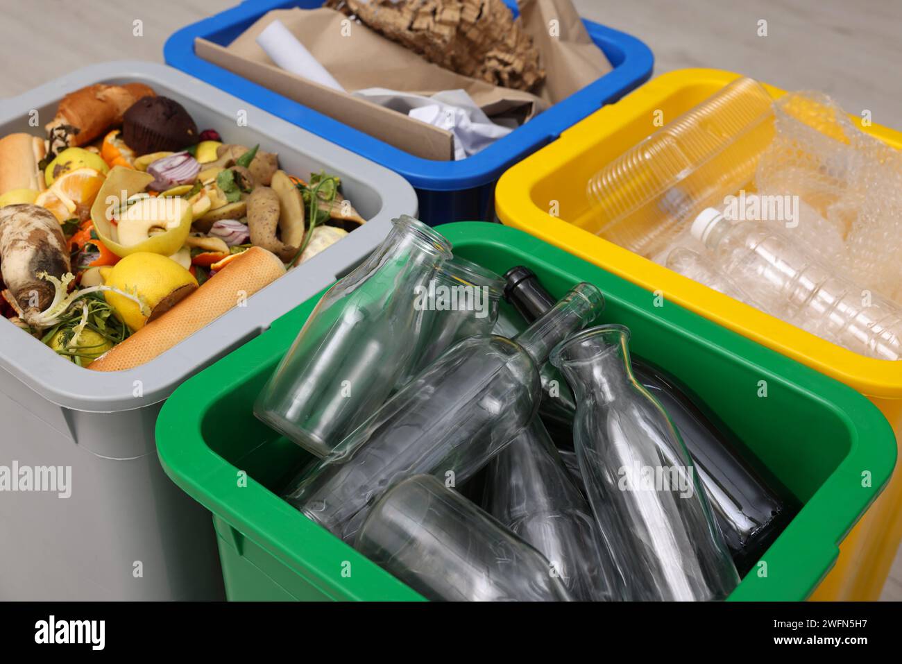 Garbage sorting. Full trash bins for separate waste collection indoors ...