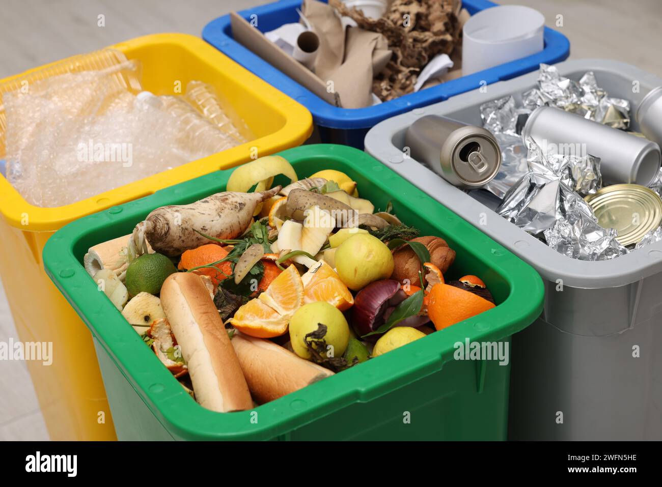 Garbage sorting. Full trash bins for separate waste collection indoors ...