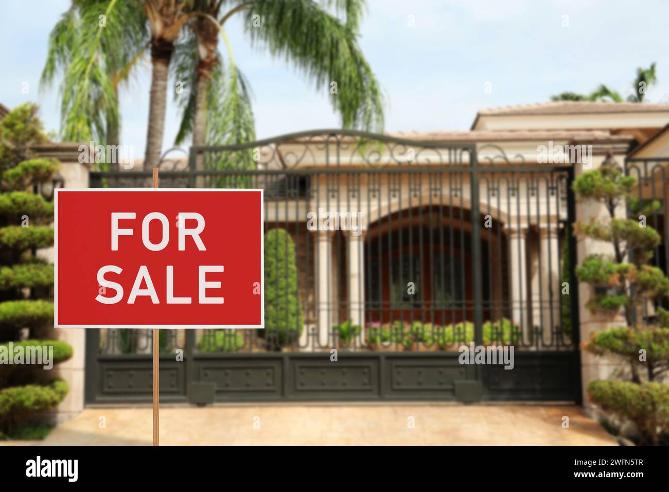 Sale sign near beautiful house outdoors. Red signboard with words Stock ...