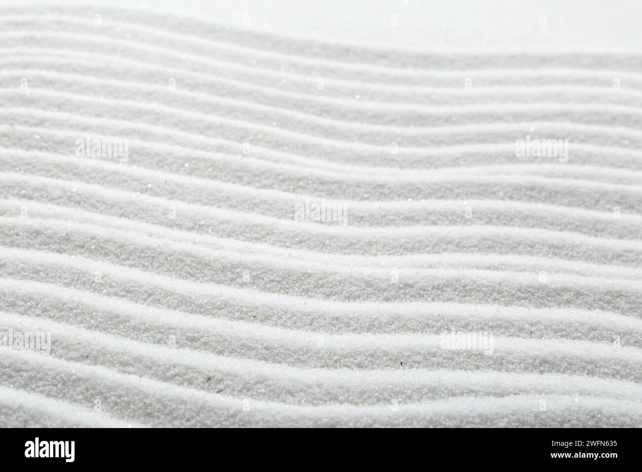 Zen rock garden. Wave pattern on white sand, closeup Stock Photo - Alamy