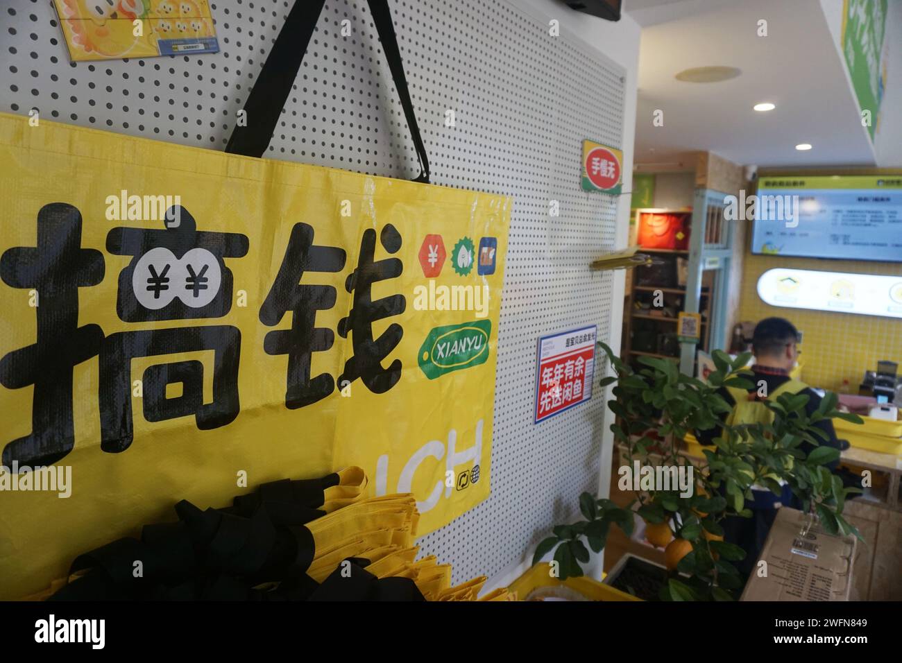 HANGZHOU, CHINA - JANUARY 31, 2024 - A SHOP assistant takes photos of ...