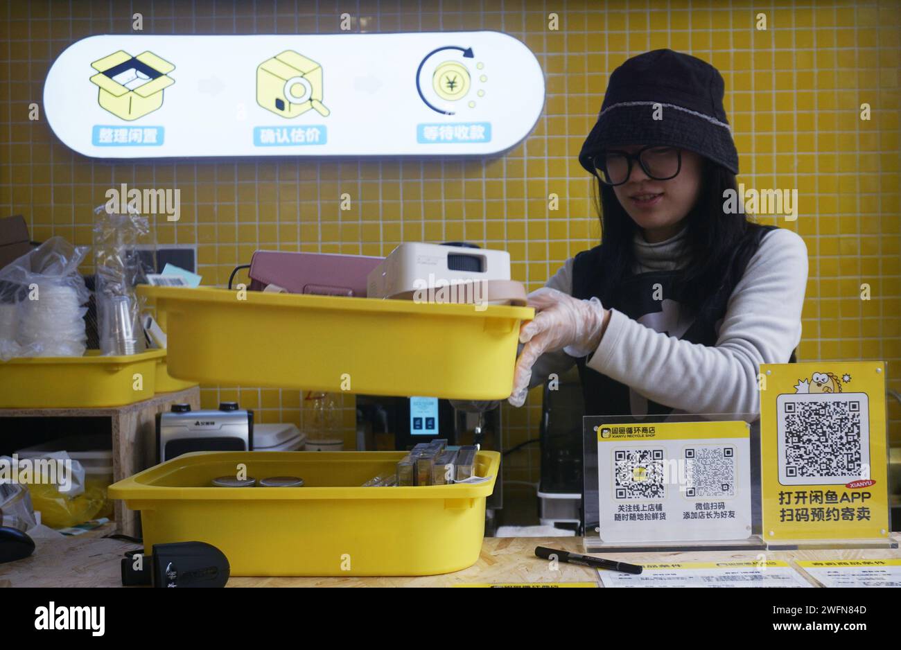 HANGZHOU, CHINA - JANUARY 31, 2024 - A SHOP assistant takes photos of ...