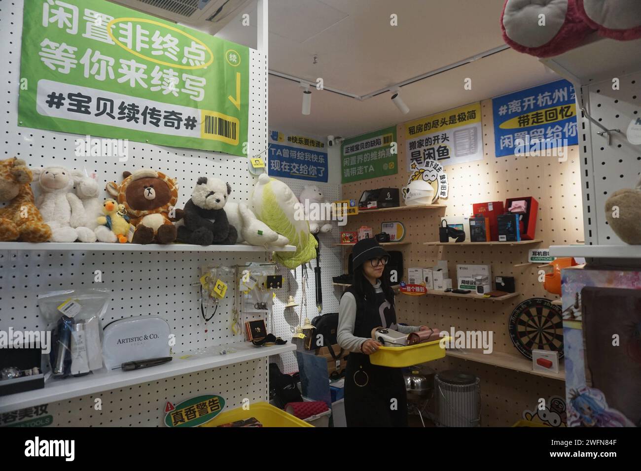 HANGZHOU, CHINA - JANUARY 31, 2024 - A SHOP assistant takes photos of ...