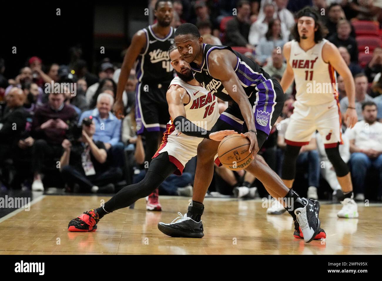 Miami Heat forward Caleb Martin (16) defends Sacramento Kings guard De ...