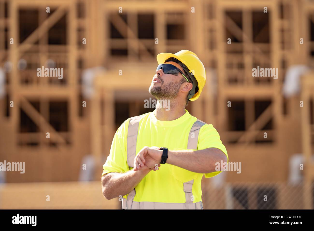 Worker in building uniform on buildings construction background ...