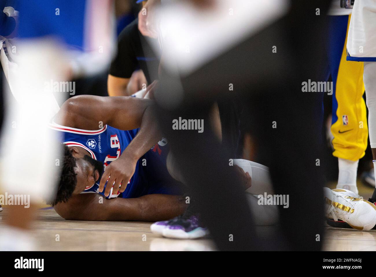 Philadelphia 76ers center Joel Embiid (21) lays on the court in obvious ...
