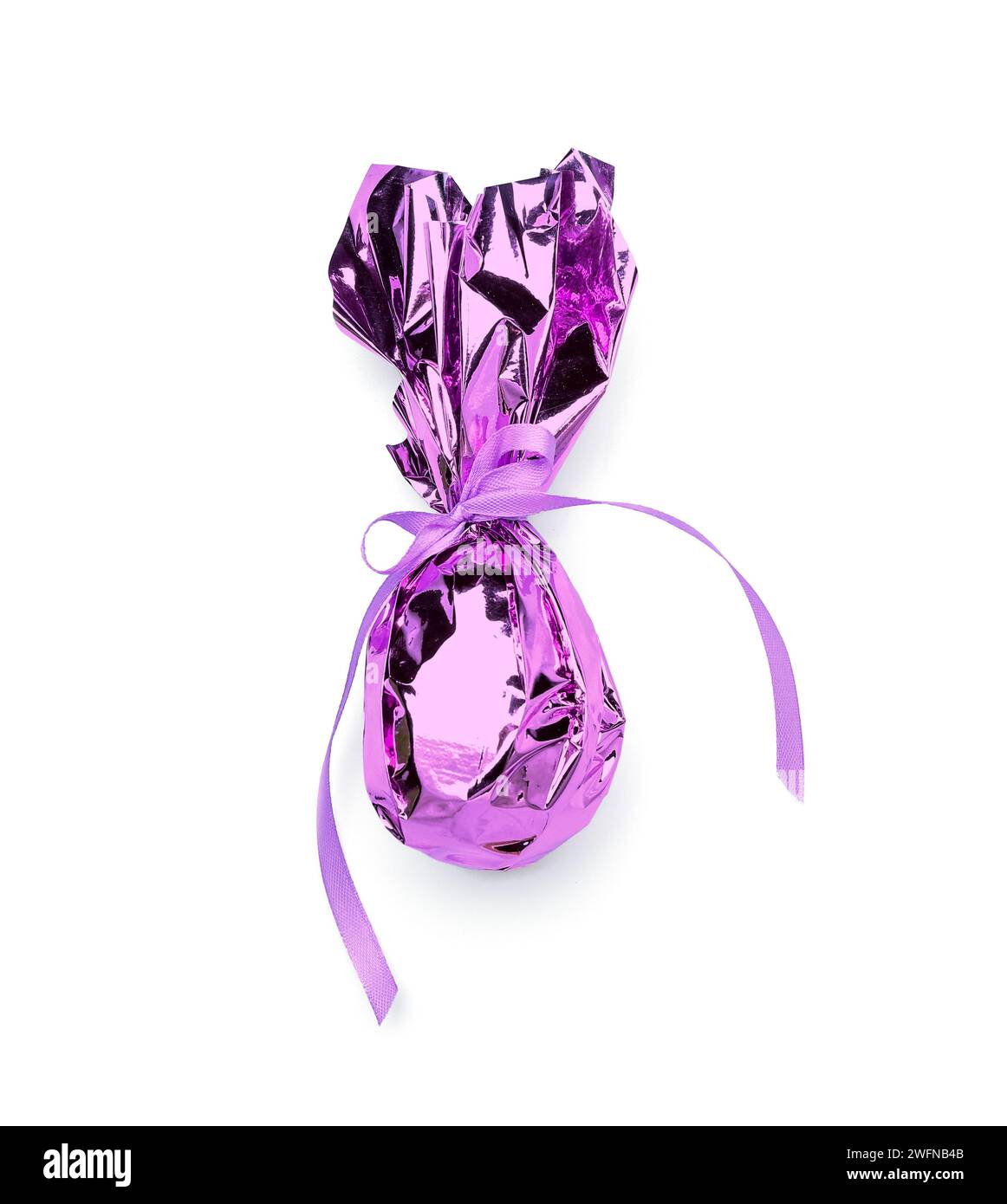 Chocolate Easter egg wrapped in foil on white background Stock Photo ...