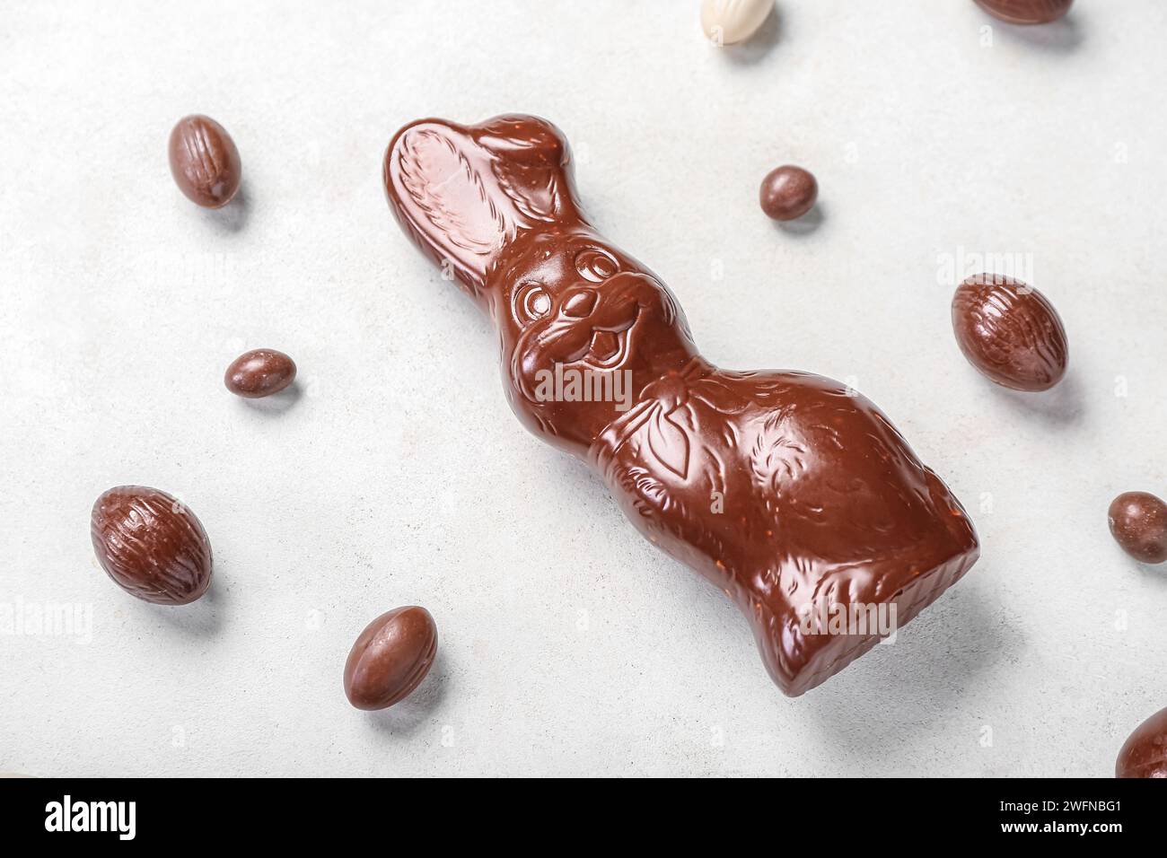 Chocolate Easter bunny with eggs on white background Stock Photo - Alamy