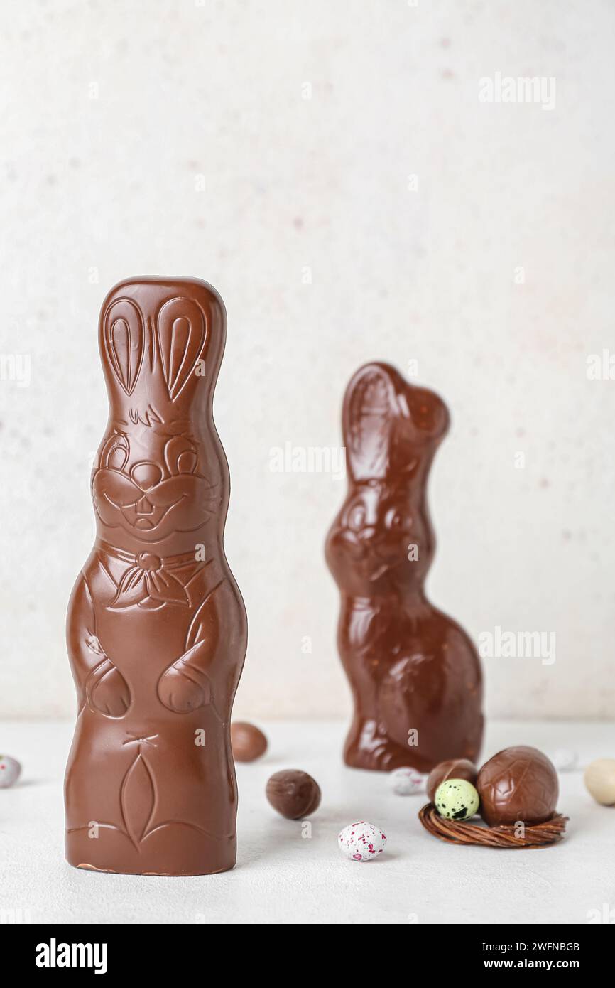 Chocolate Easter bunnies with eggs on white background Stock Photo - Alamy