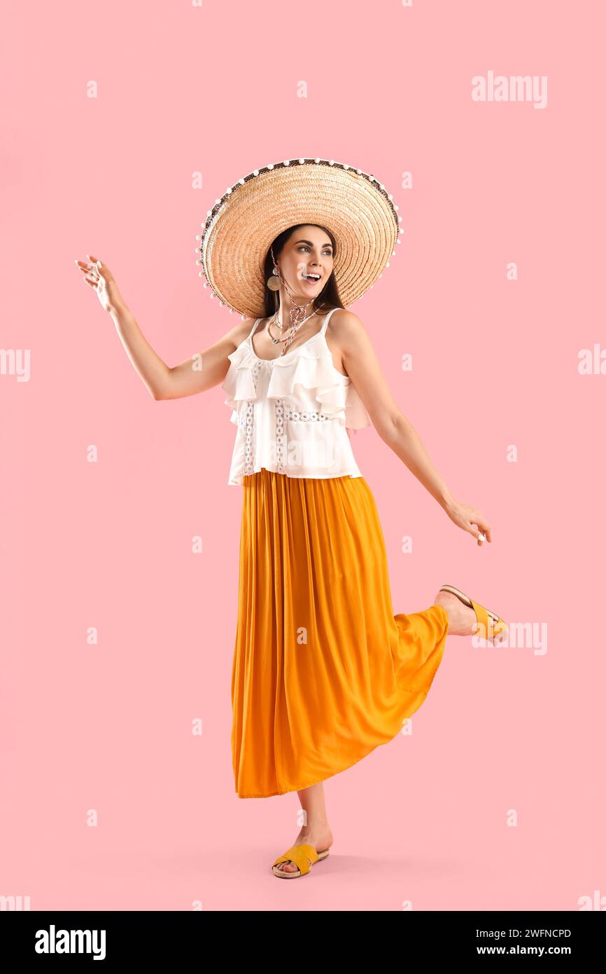 Dancing woman in sombrero hat on pink background Stock Photo - Alamy
