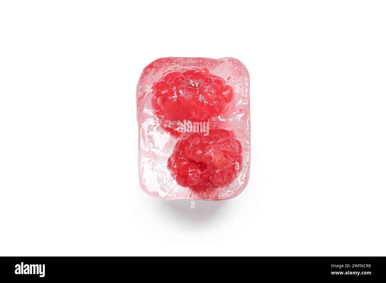 Frozen raspberries in ice cube on white background Stock Photo - Alamy