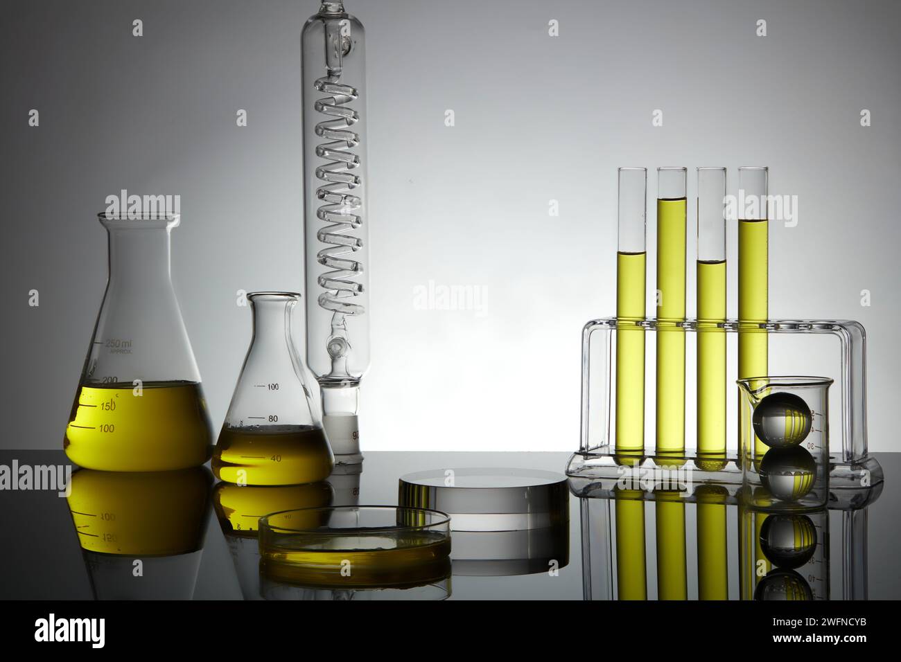 Yellow fluid is contained inside laboratory glassware displayed with a ...