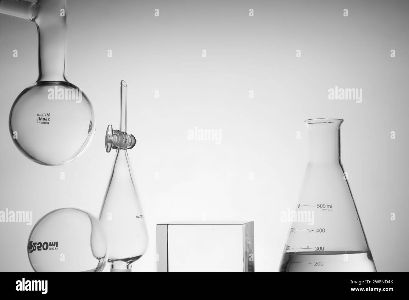 An erlenmeyer flask filled with water and scientific glassware ...