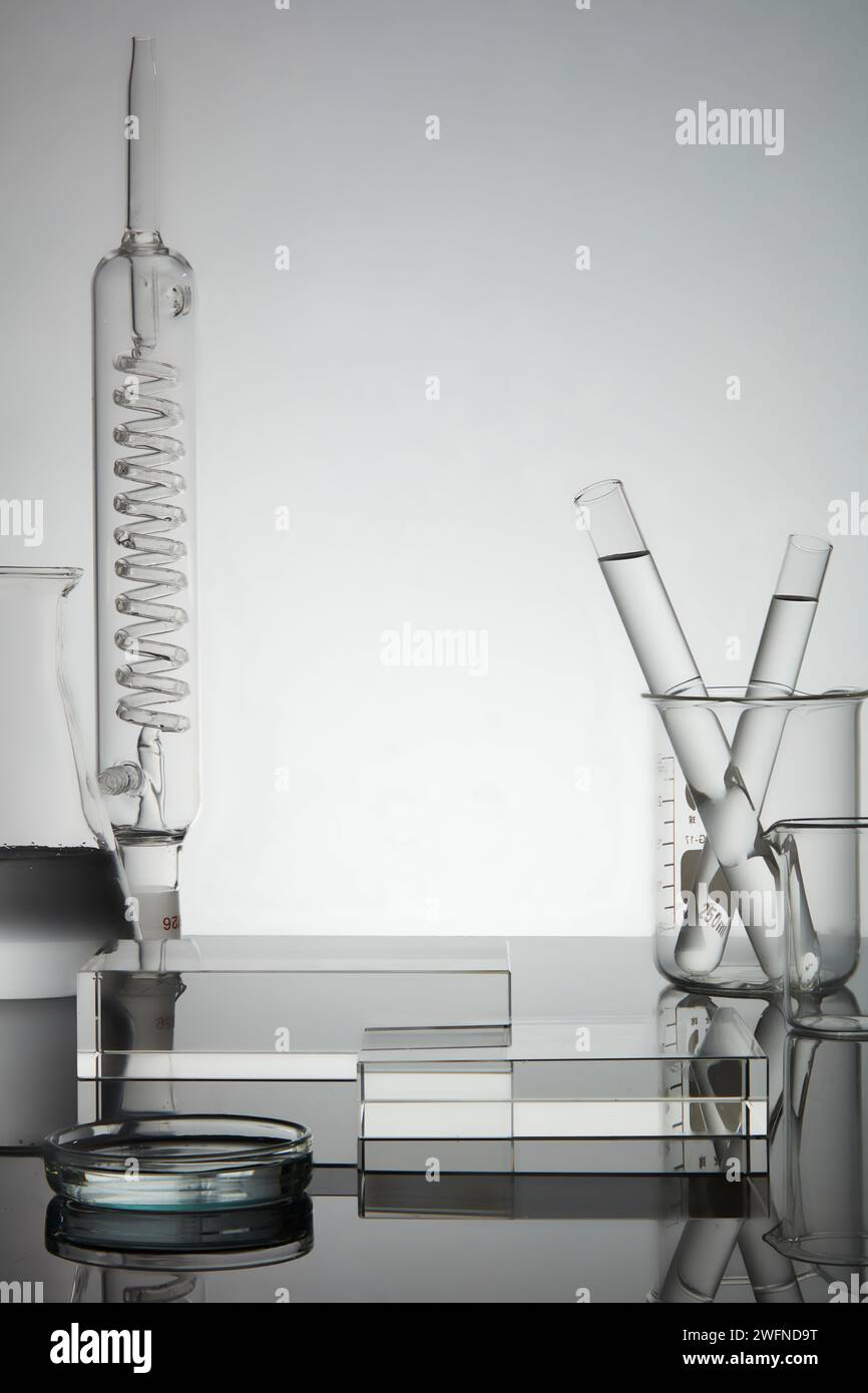 Test tube, petri dish filled with water and laboratory glassware ...