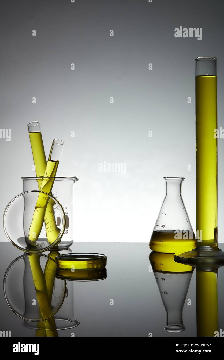 Scientific glassware filled with yellow liquid decorated on minimalist ...