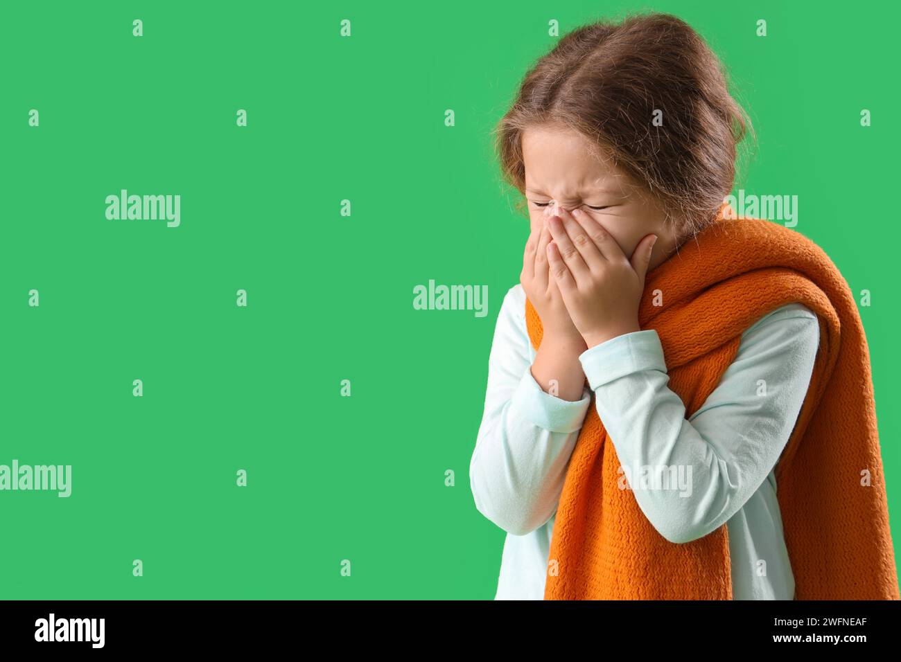 Sick little girl in scarf on green background Stock Photo - Alamy