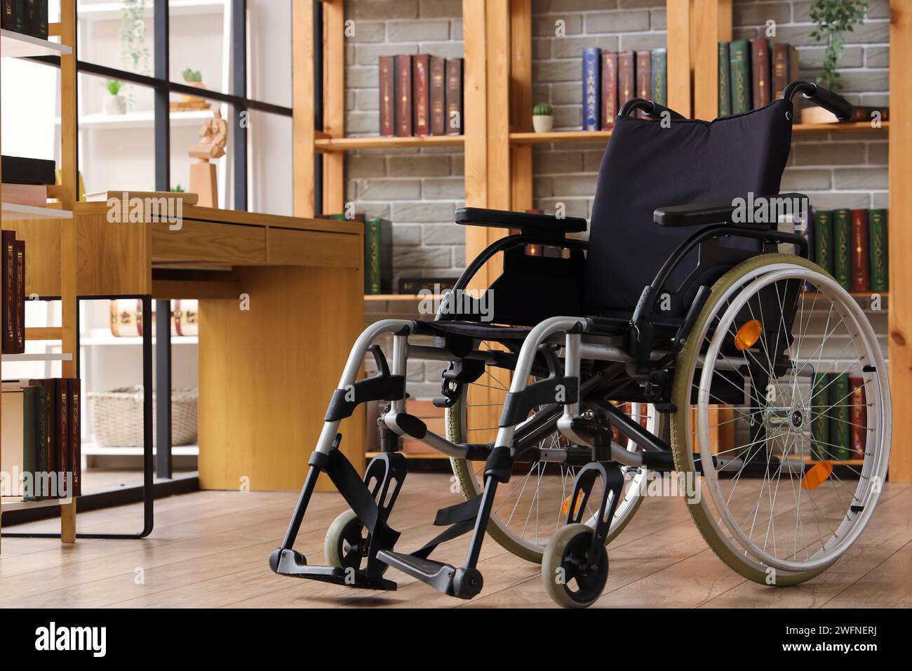 Modern wheelchair in interior of library Stock Photo - Alamy