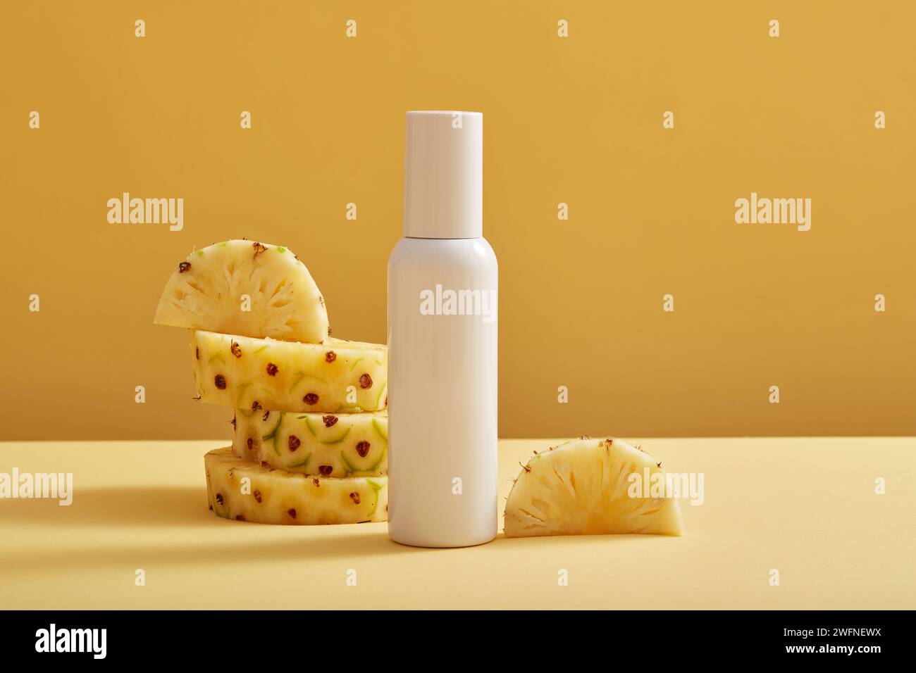 An empty label bottle in white color decorated with pineapple (Ananas ...