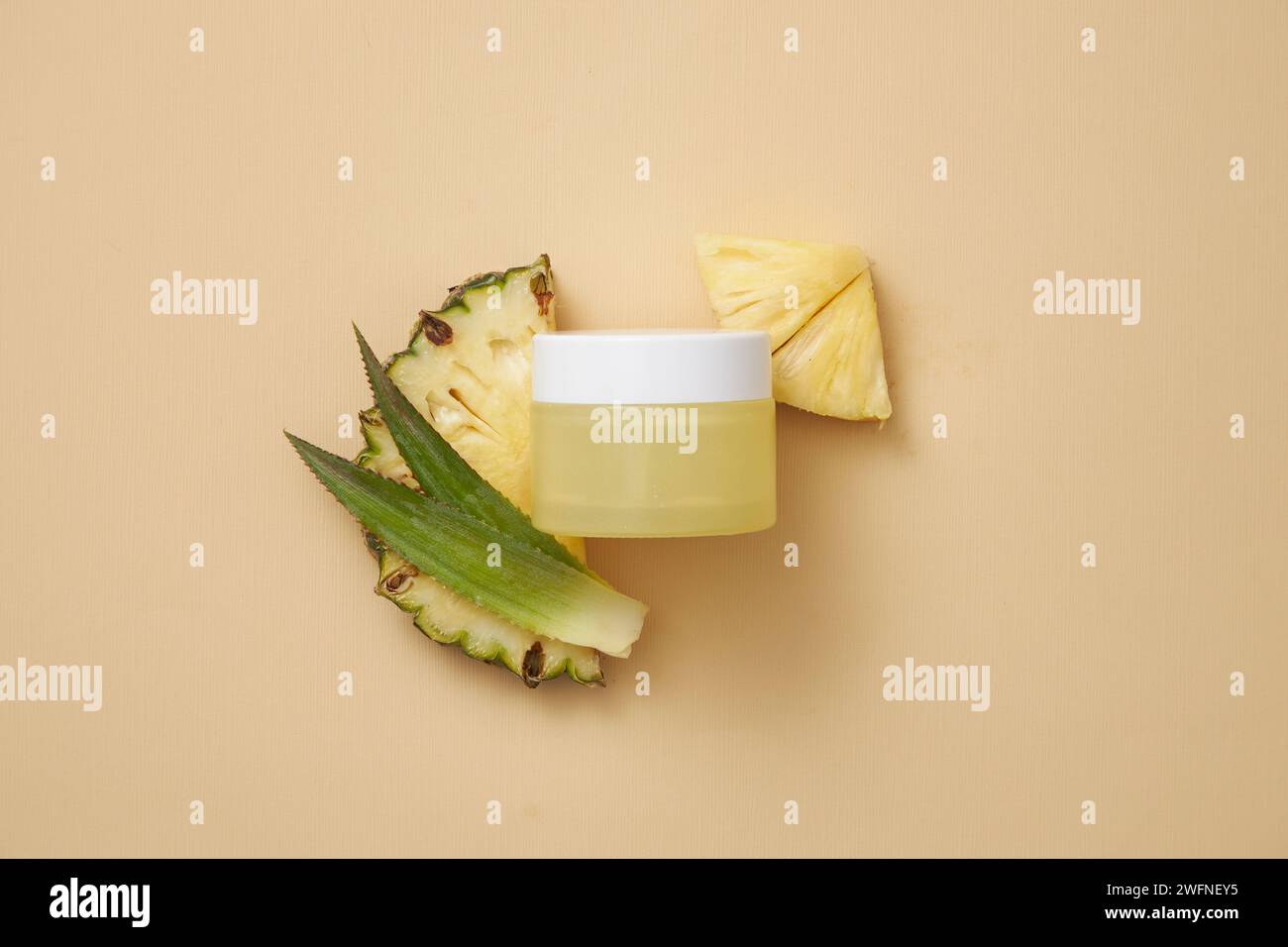 Over the pastel background, a jar without label is decorated with ...