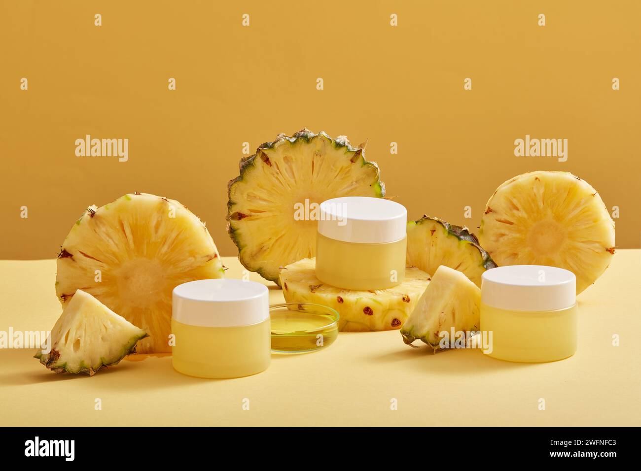 Three jars with empty label and a petri dish of pineapple essence ...